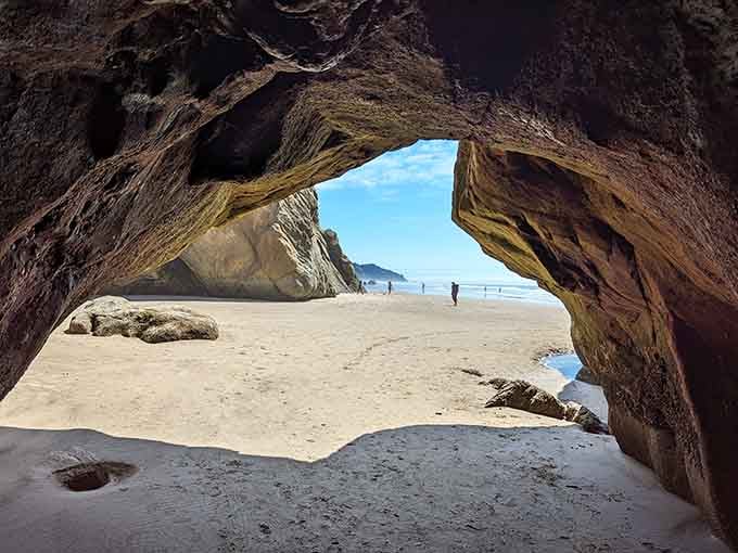 Peering through this natural arch feels like stepping into a secluded paradise with the beach beyond.