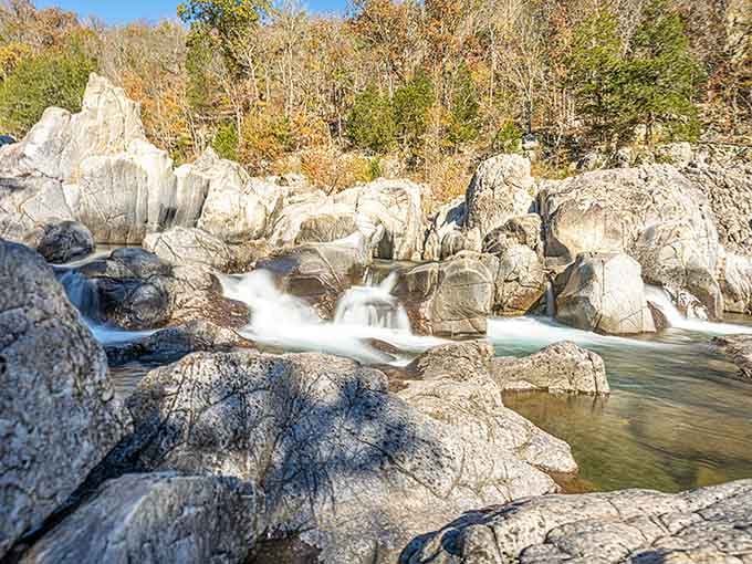 Autumn colors frame the cascading waters as they dance over ancient rhyolite in this geological playground.