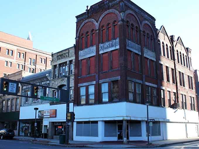 Historic brick buildings stand proud against the hillside, telling stories of industrial heritage and community resilience through the decades.