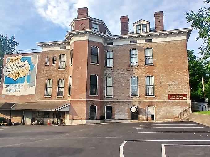 The elegant brick facade hides generations of family tragedy behind those tall, arched windows and ornate details.