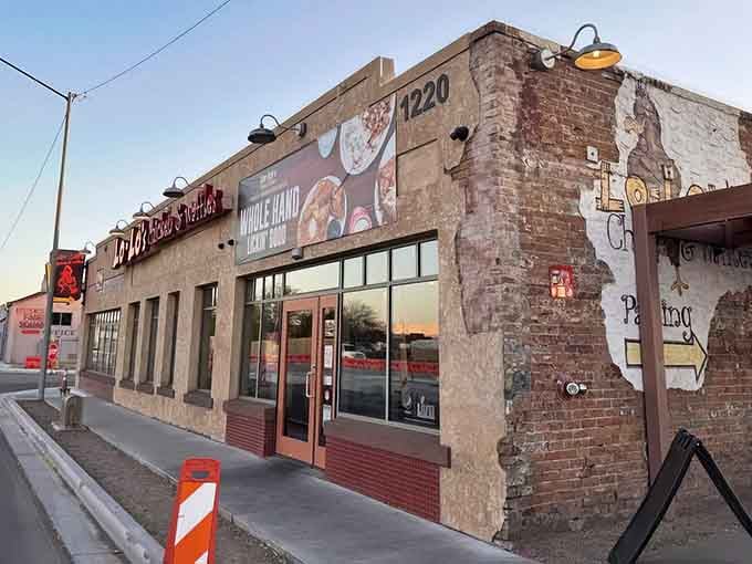 When sunset hits those exposed brick walls, you know crispy fried chicken and fluffy waffles are waiting inside.
