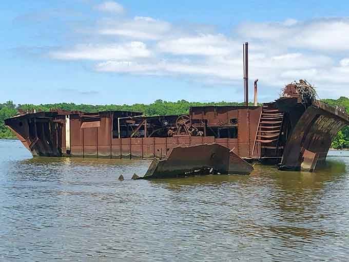This WWI-era vessel tilts dramatically from the water, its weathered hull telling stories of a bygone maritime era.