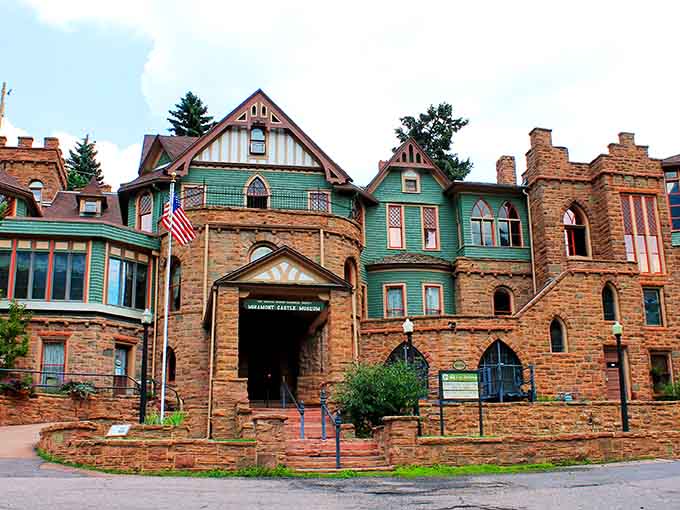The green trim pops against that gorgeous stonework, making this castle look like it wandered over from England.
