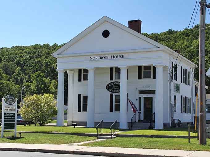 The Norcross House stands proud in white, a testament to New England architecture that's stood the test of time.