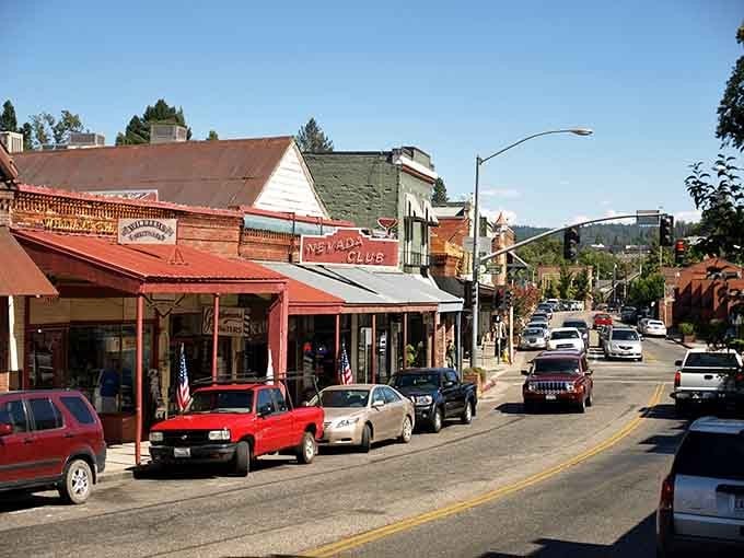 The red-trimmed storefronts and bustling main street create a scene straight out of California's Gold Rush glory days, beautifully preserved.