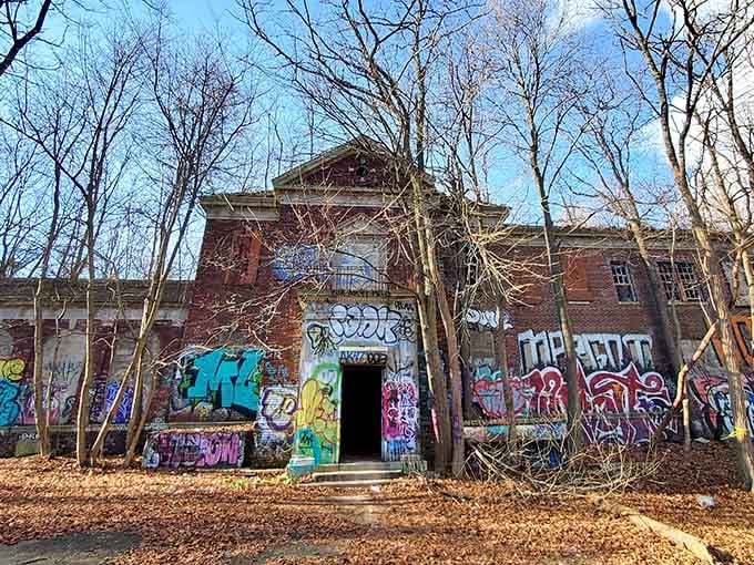 Bare trees frame crumbling brick like a scene from every ghost story your grandmother ever told you.