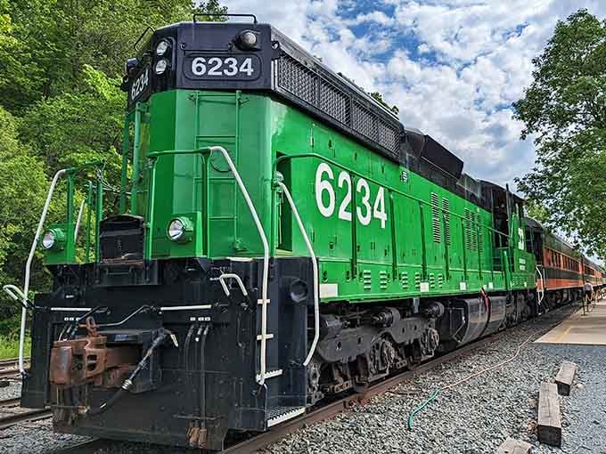 The bright green engine stands proud on the tracks, a powerful reminder of railroading's golden era in America.