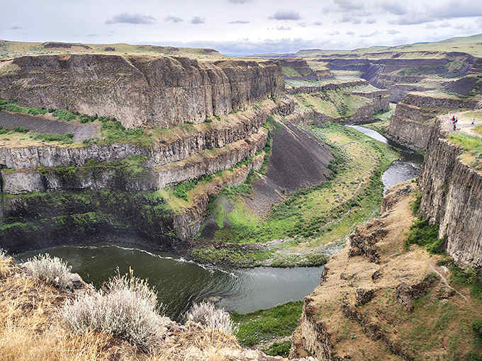 The horseshoe canyon reveals layers of ancient rock history while that ribbon of water keeps flowing strong.