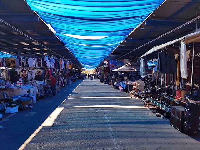 Blue shade canopies transform ordinary shopping into a cool, comfortable adventure even under the desert sun.