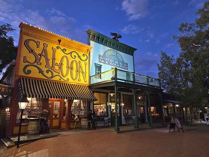As twilight settles over these vintage facades, the saloon and steakhouse glow with warmth, history, and hungry anticipation.