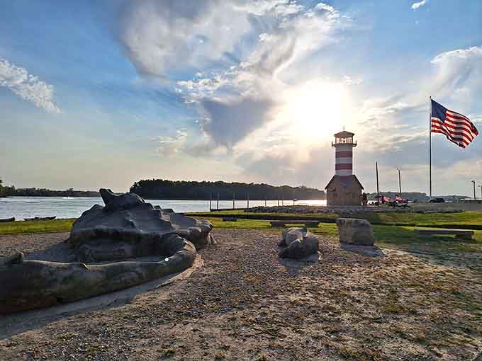 Golden hour transforms this patriotic lighthouse into pure magic, with dramatic clouds stealing half the show behind it.