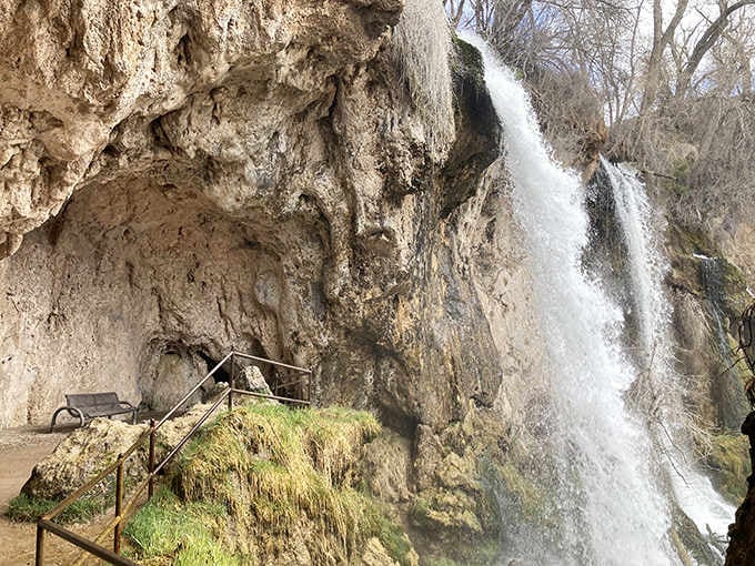 Moss-covered rocks and cascading water frame this hidden oasis where you can actually walk behind the falls.