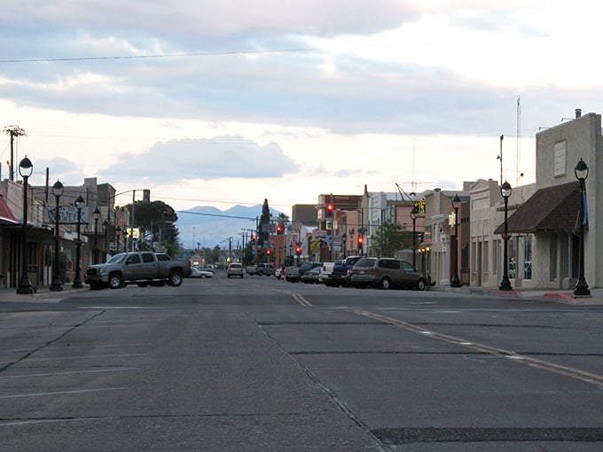 Mountains frame the horizon as modest light paints the street in welcoming tones.