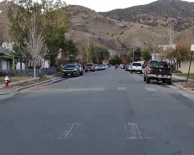 Rolling hills embrace quiet residential streets where neighbors still wave from their front porches.