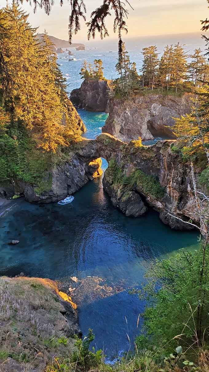 Golden hour transforms these natural rock arches into something from a fantasy novel, complete with that impossibly blue water below.