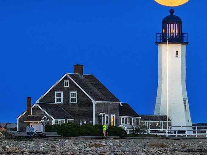 That full moon rising behind the lighthouse creates a scene straight out of a Norman Rockwell painting.