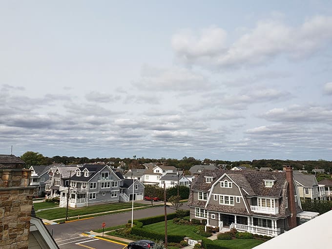 Those dramatic clouds over manicured lawns and elegant architecture create a postcard-perfect coastal community scene worth savoring.