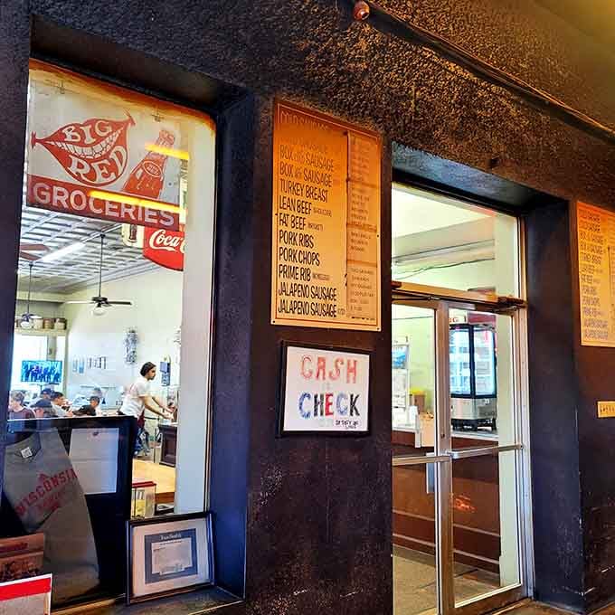 Through smoke-stained windows, you glimpse the heart of a legendary operation where meat meets fire with beautiful results.