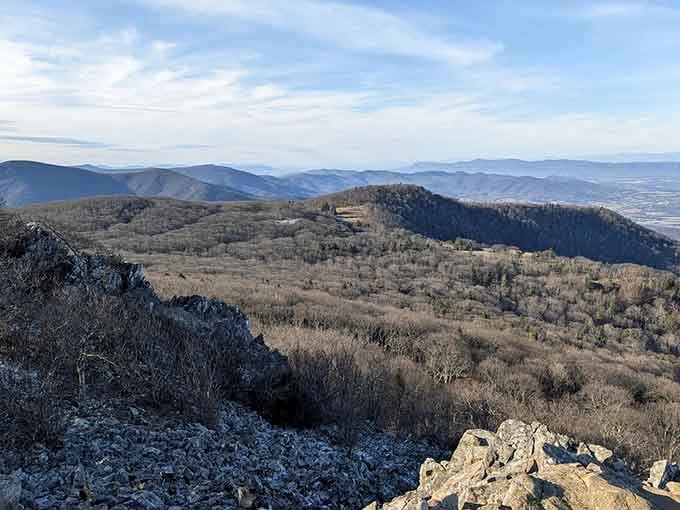 Layered mountain ridges fade into misty blue distance like a watercolor painting that never quite dries completely.