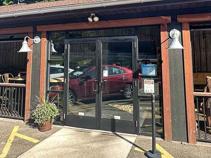 Those glass doors frame the promise of rustic elegance inside, where cabin comfort meets culinary excellence every single night.