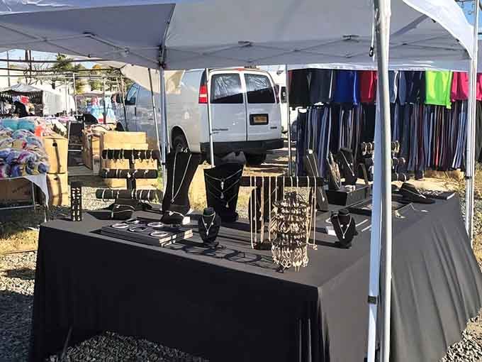 Jewelry glitters across the table while racks of colorful finds turn this booth into a cheerful little treasure stop.