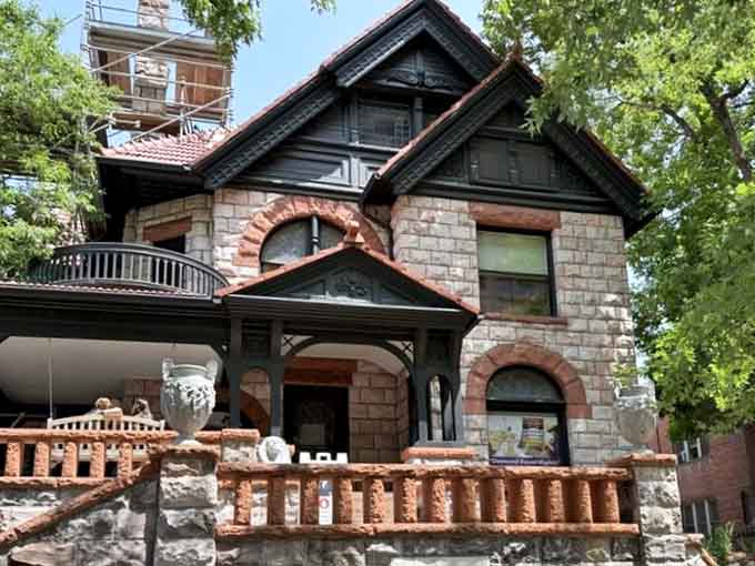 Summer greenery frames this stunning example of 1880s craftsmanship with its distinctive arched windows and balconies.