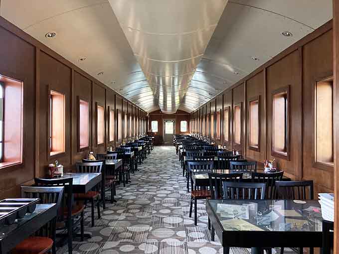 Step inside this gleaming train car interior where every booth feels like a first-class ticket to flavor town.
