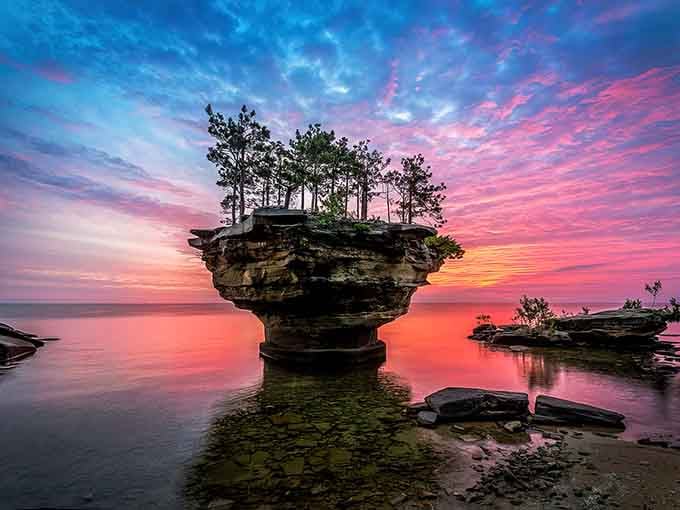 Sunset paints this impossible rock formation in cotton candy colors, making it look even more like a fantasy movie set.