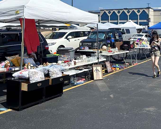 White tents dot the asphalt like a village of possibilities where every table holds something you didn't know you needed.