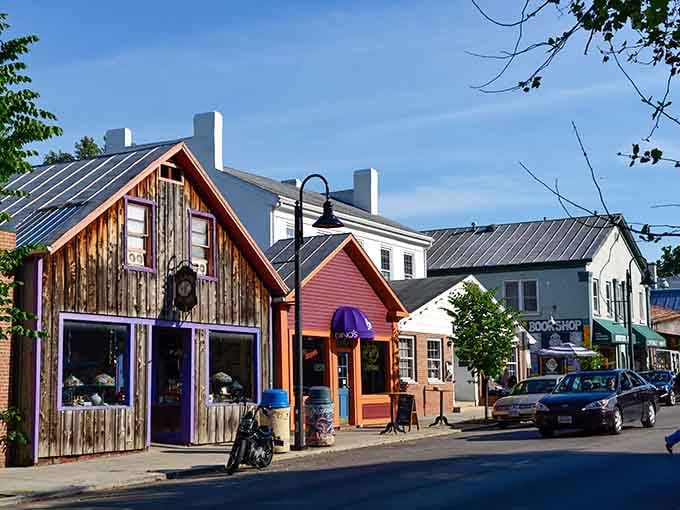 Rustic wooden buildings mix with colorful facades creating a bohemian vibe that feels refreshingly authentic and inviting.