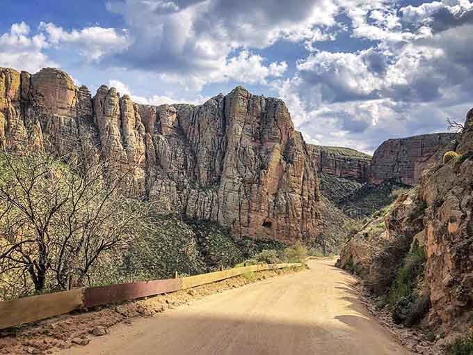 Those striped canyon walls flanking the dirt road prove Mother Nature has better decorators than HGTV.
