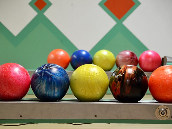 Each colorful sphere has rolled thousands of frames, carrying dreams of strikes and stories of spares.