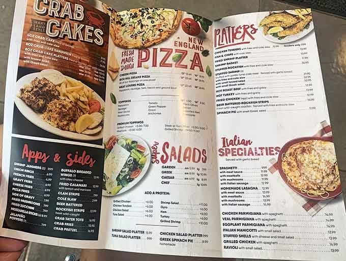 The menu reveals a glorious dilemma: pizza perfection or legendary crab cakes calling your name from every corner.