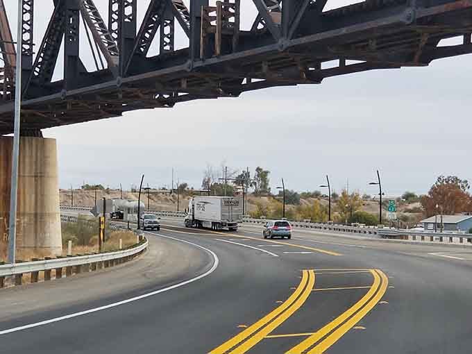 Driving under that bridge feels like passing through a gateway to adventure, minus the tollbooth and traffic jams.