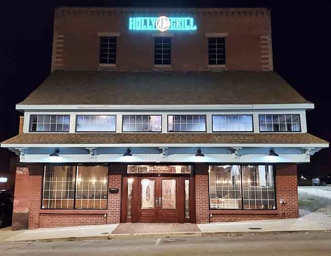 The Holly J's Grill building glows like a beacon for anyone who appreciates history served with a side of character.