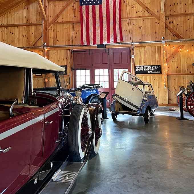 An American flag presides over gleaming chrome and polished paint, celebrating our nation's automotive heritage with proper reverence.