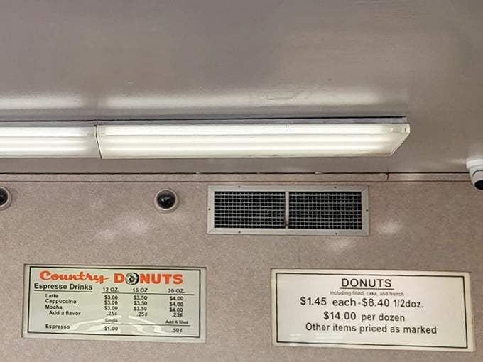 The menu board speaks a language everyone understands: coffee, donuts, and the promise of a better morning ahead.