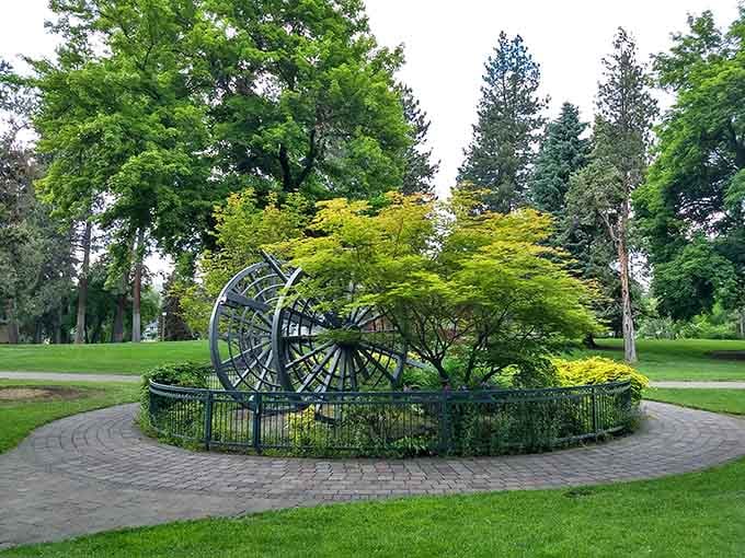 That vintage wheel sculpture celebrates Bend's logging heritage with more style than most modern art installations could dream of.