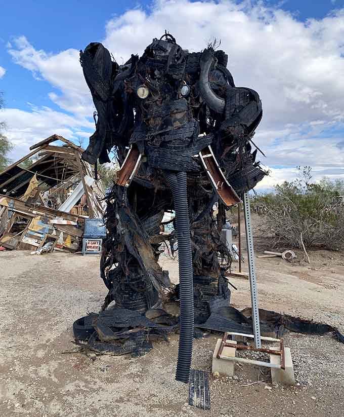 This towering creature fashioned from burnt metal and industrial parts stands guard like a post-apocalyptic sentinel.