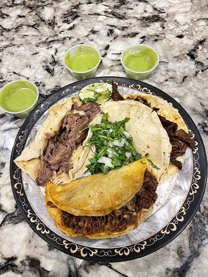 A glorious taco feast with tender meats, fresh tortillas, and that vibrant green salsa begging to be devoured.