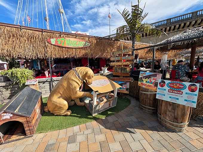 A golden retriever sculpture guards the village because even fake England needs proper canine companionship.