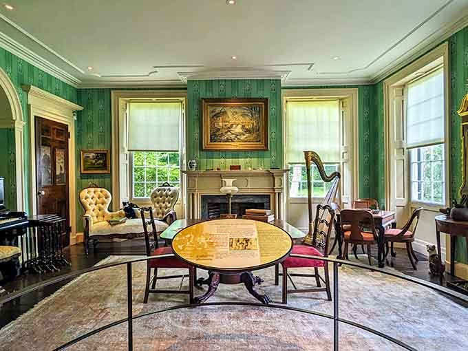 Green walls, period furniture, and a harp in the corner because apparently these artists knew how to live.