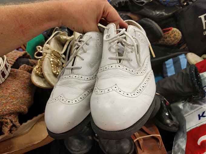 White oxford shoes emerge from the chaos proving that somewhere in these bins your perfect pair awaits discovery.