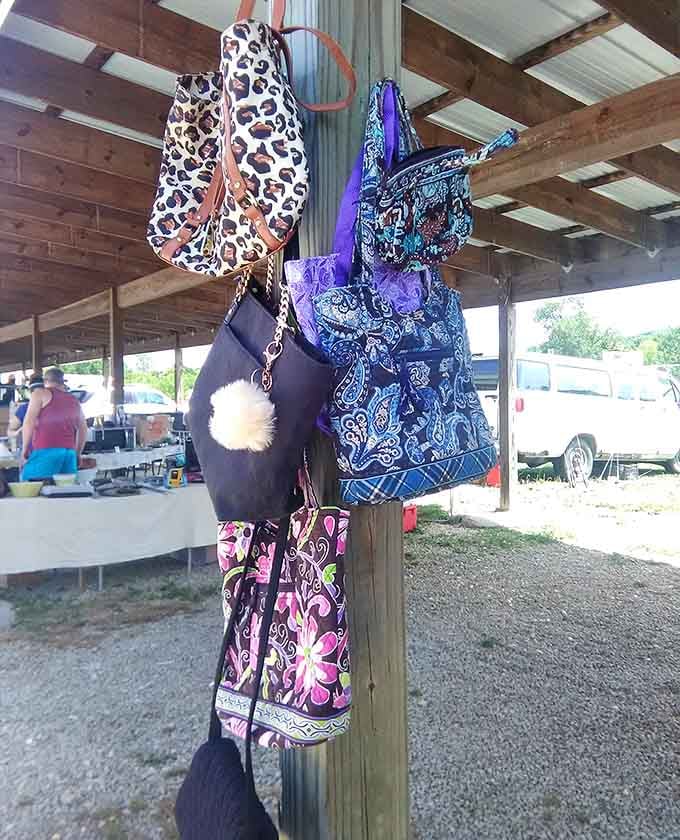 Handbags hanging like colorful fruit on a very fashionable tree, each one ready to carry your flea market finds home.