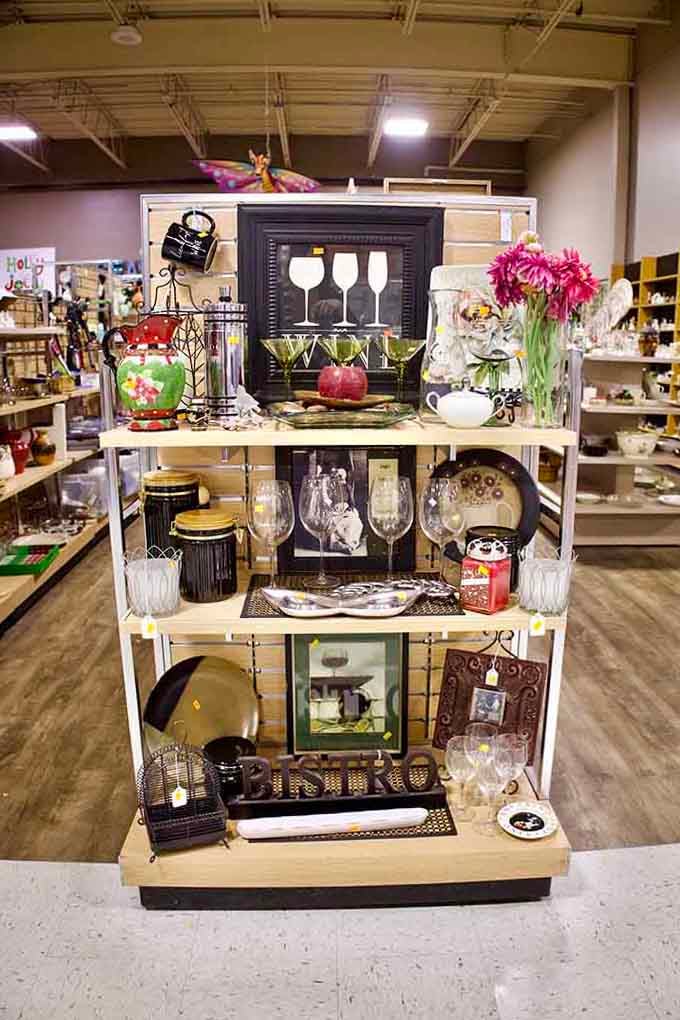 Wine glass art and vintage finds create a display so charming, you'll wonder why anyone pays full price.