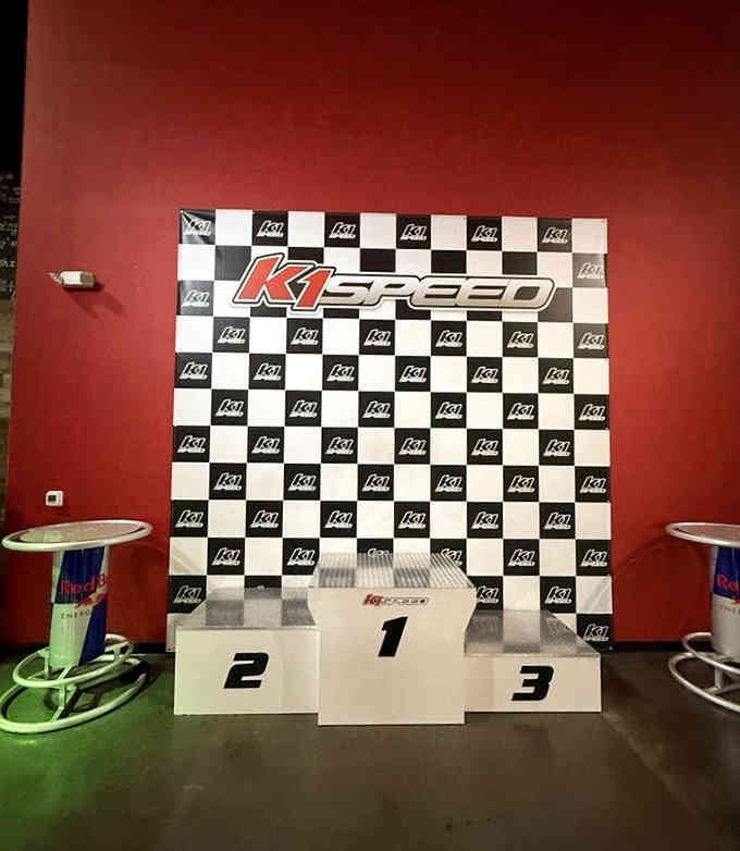 Stand on that podium and suddenly you're accepting an imaginary trophy for Best Driver in Your Friend Group.