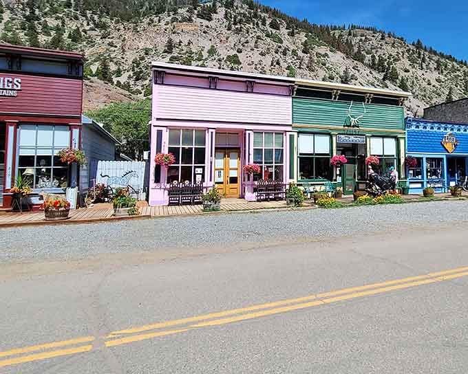 Pink, green, and blue buildings line up like a cheerful paint sample display that actually got built into a real town.