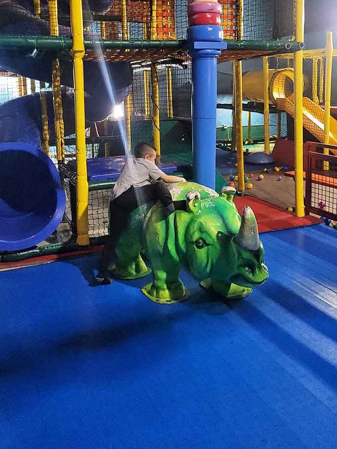Even the dinosaurs want in on the fun at this multi-level playground that defies architectural logic beautifully.