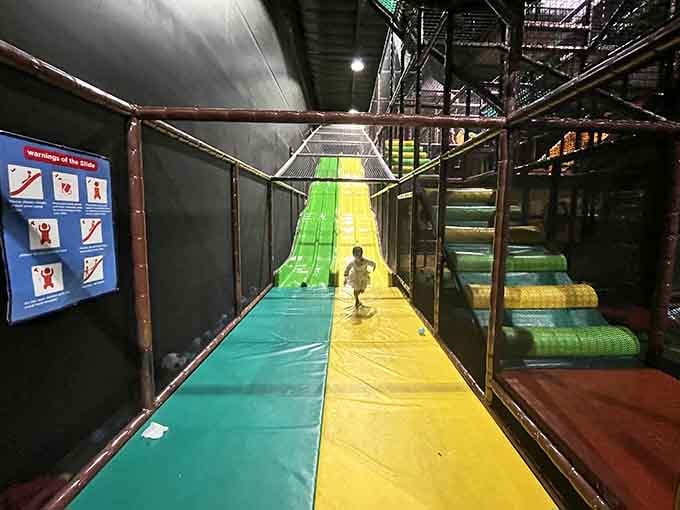 Those colorful slides stretch down like rainbow highways, perfect for kids who think walking is overrated anyway.