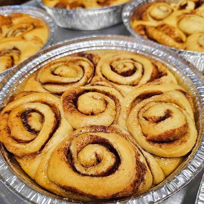 Behold the cinnamon roll mothership: golden spirals of joy arranged like edible works of art in aluminum pans.